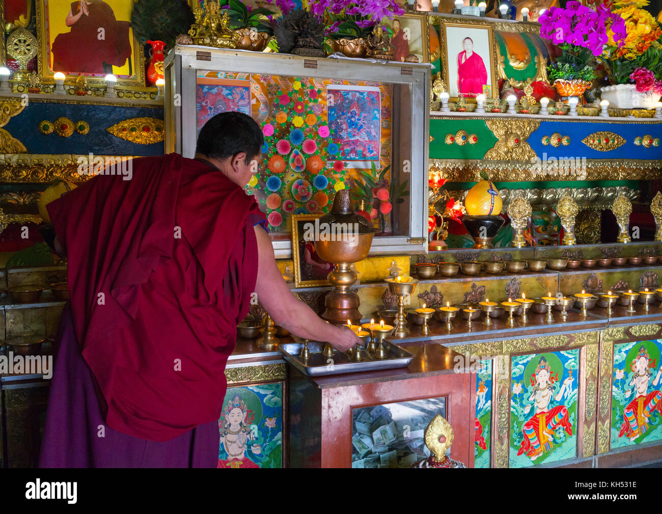 tibetan Monk lightening butter lamps inside Rongwo monastery, Tongren ...