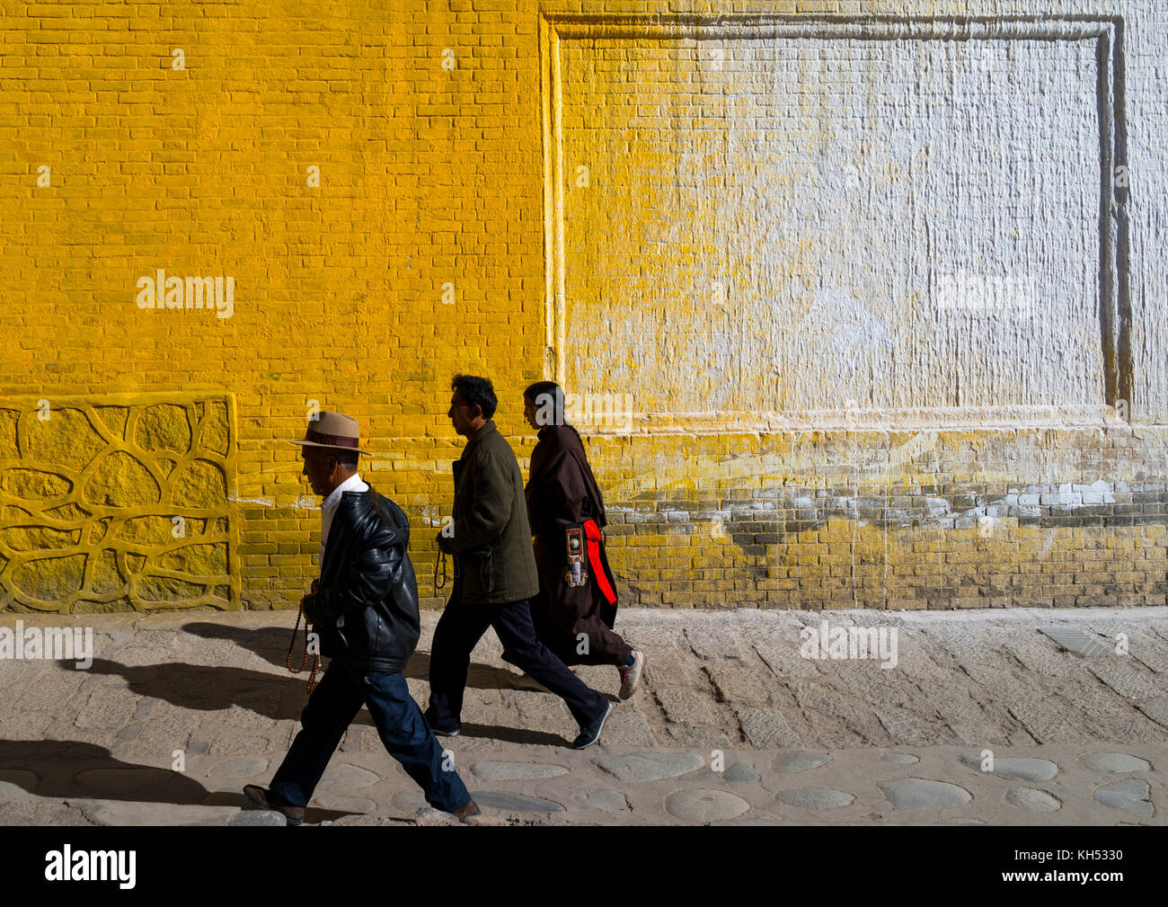 Tibetan pilgrims in traditional dress at kora around Rongwo monastery ...