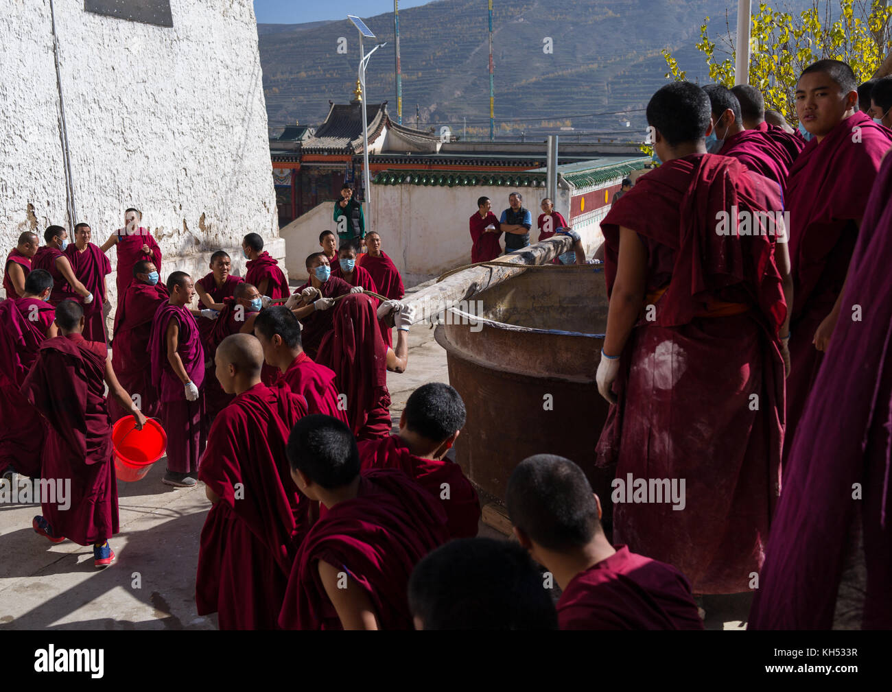 Monks preparaing the painting of a temple in Rongwo monastery, Tongren ...