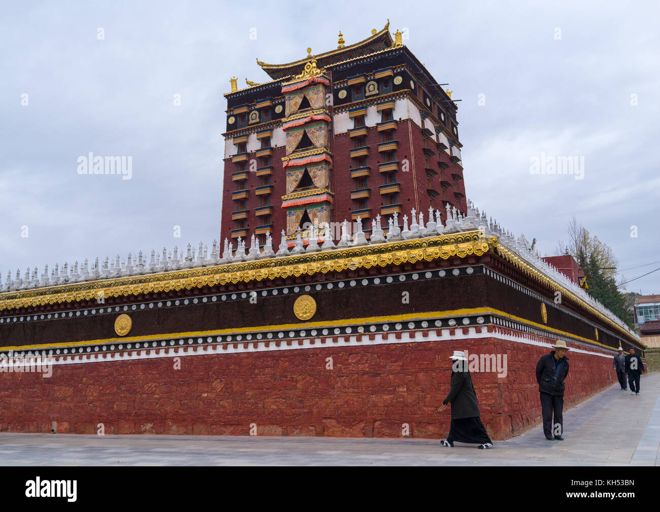 Tibetan pilgrim doing kora around Hezuo monastery and its milarepa ...