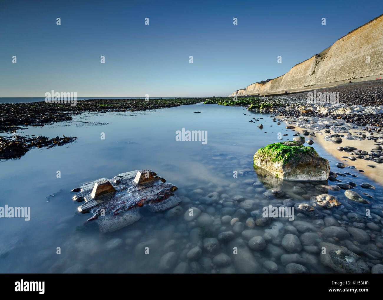 rock pool with sea defence relic Stock Photo - Alamy
