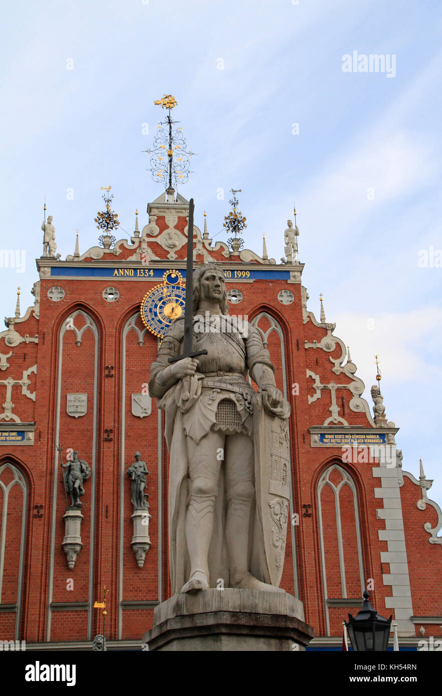 Statue in front of red building in Riga, Latvia Stock Photo - Alamy