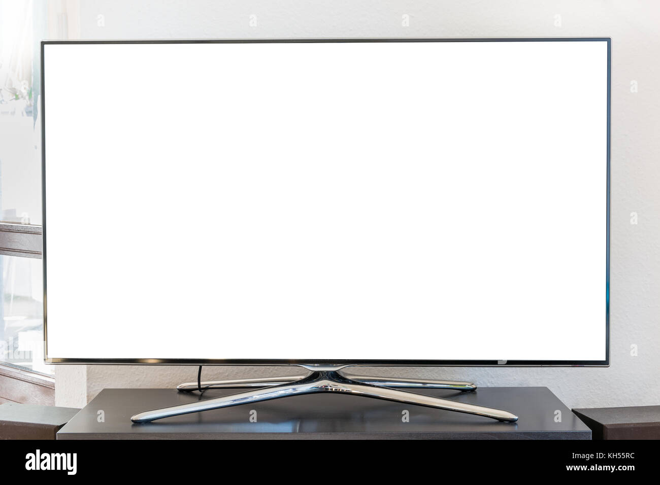 Blank white TV screen on a wooden stand in the living room from the ...