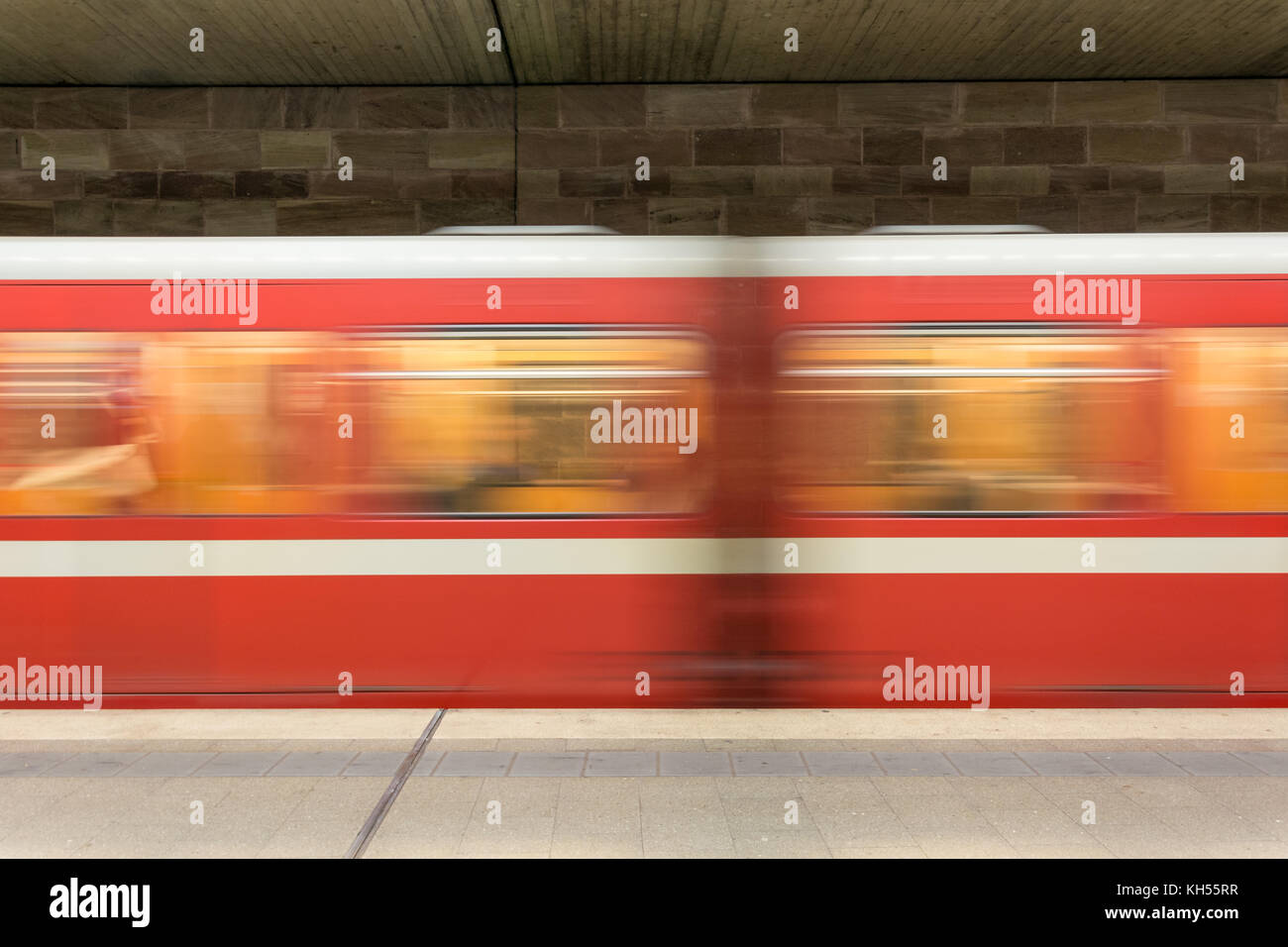 Moving red and white subway in the underground going past from the side ...