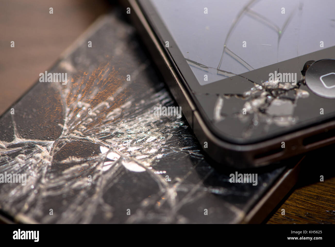 two smartphones, iphone, with broken glass Stock Photo - Alamy