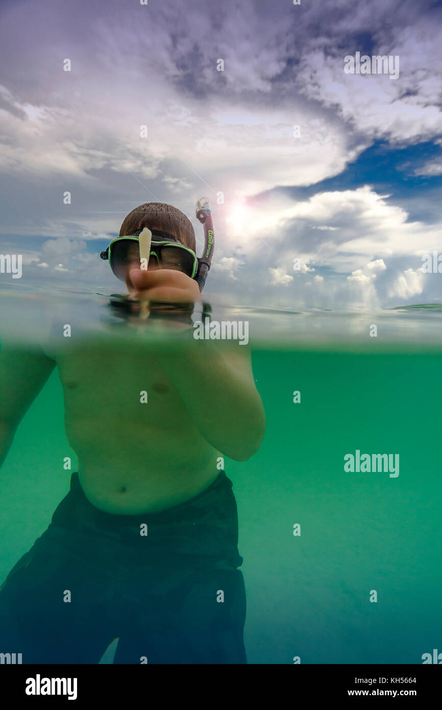 Young boy diving for sea shells Stock Photo - Alamy