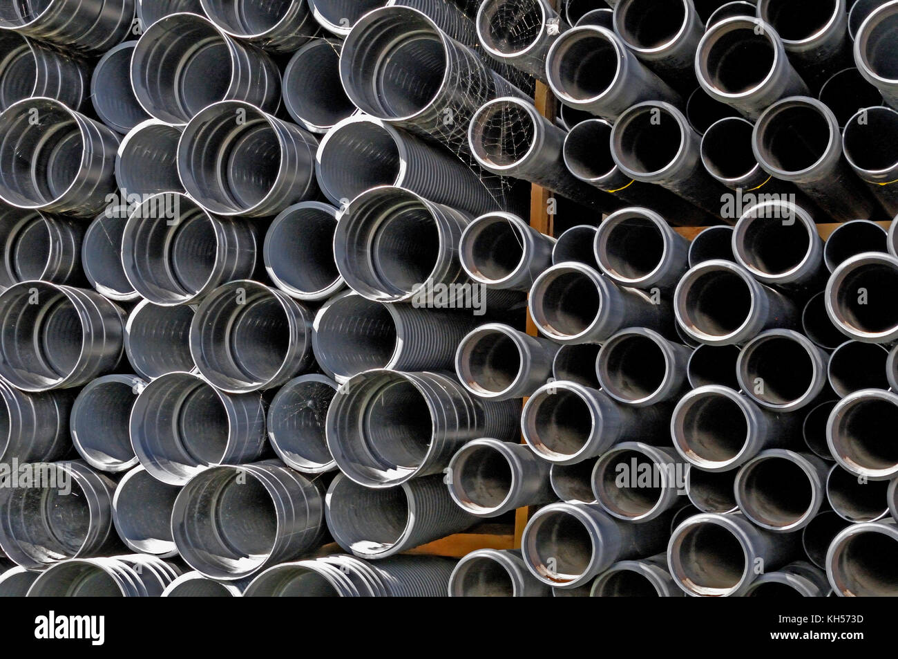 black plastic tubes stored at construction site Stock Photo - Alamy