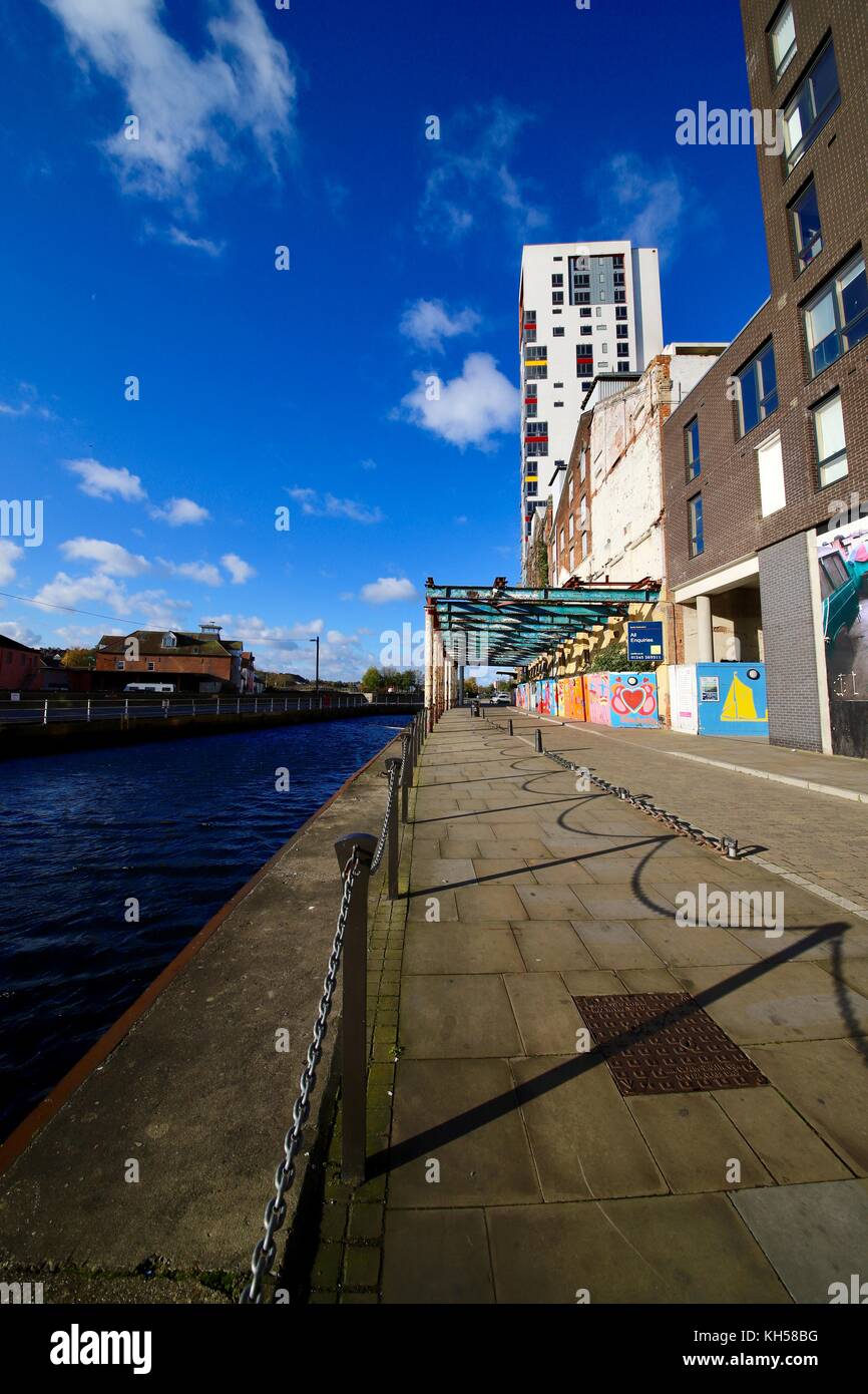 Pedestrian walkway at the redeveloped Ipswich docks with bright urban ...