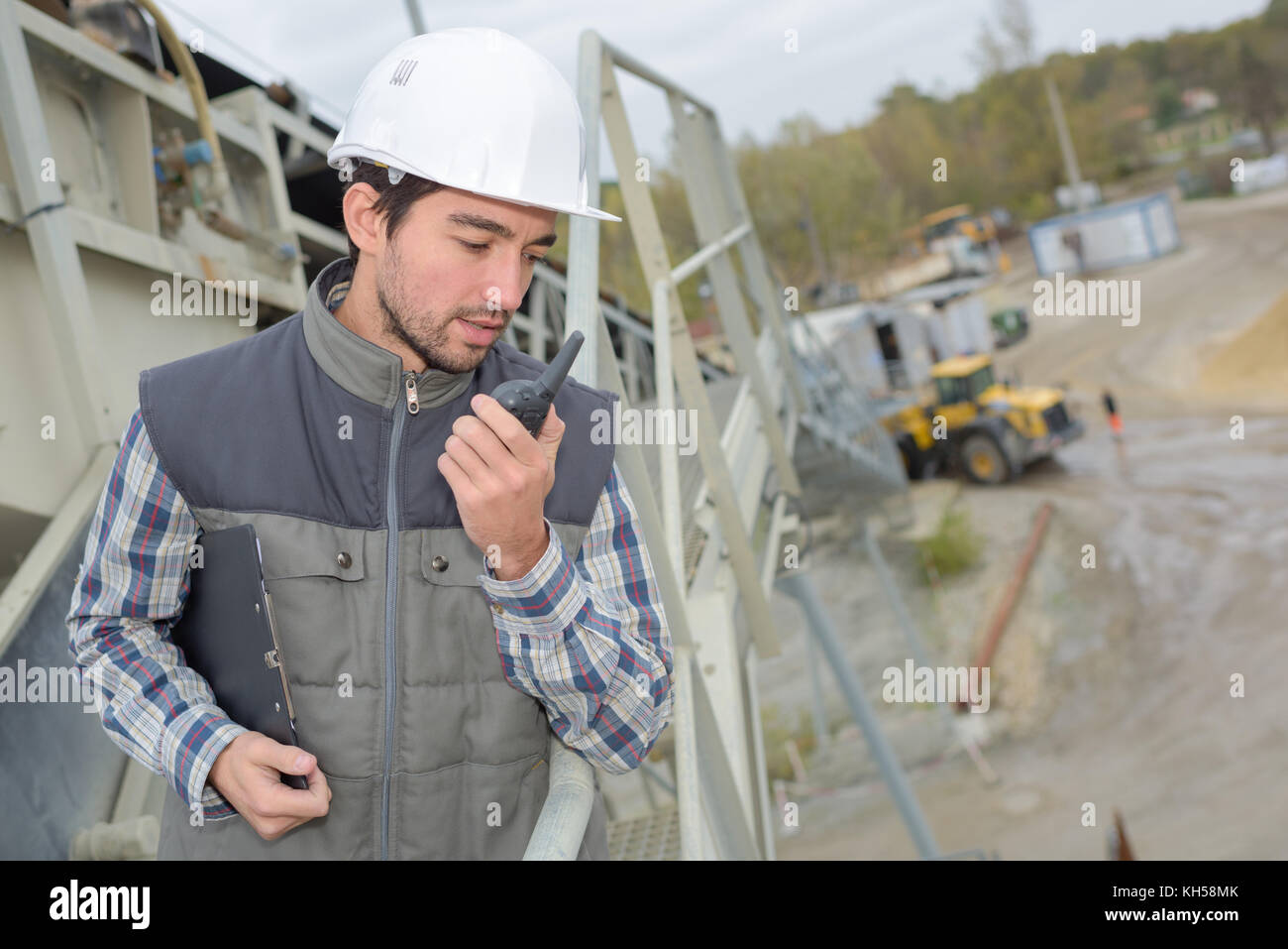 worker using radio on construction site Stock Photo - Alamy