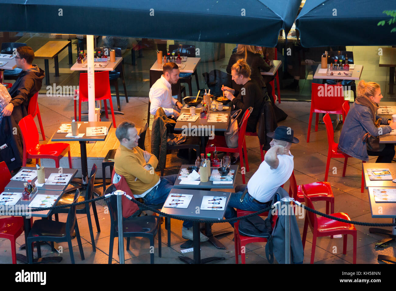 People eating at tables outside café, Southbank, London Stock Photo - Alamy