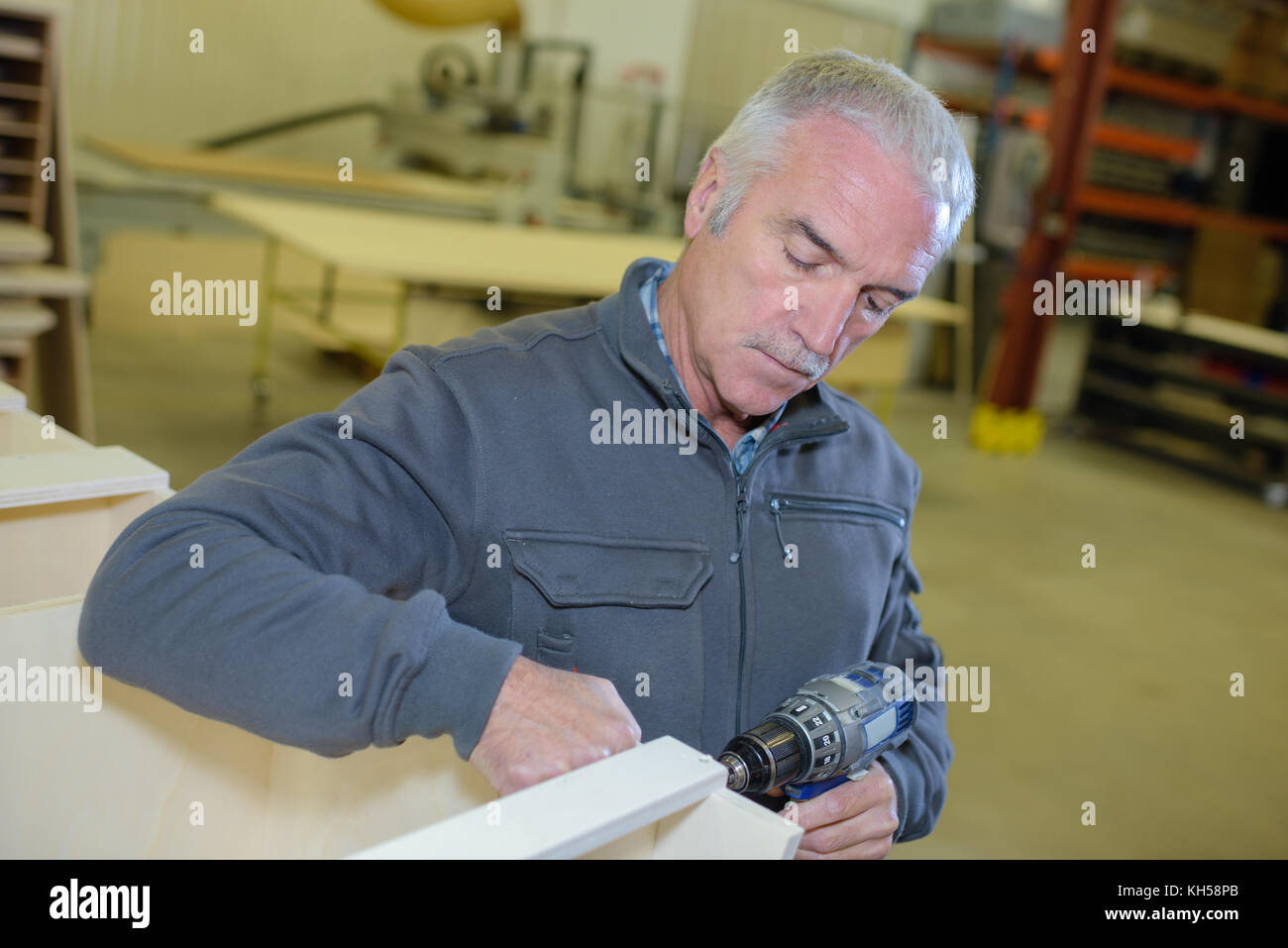 carpenter drilling the wood Stock Photo - Alamy