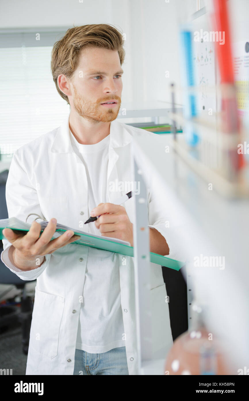 scientist in laboratory taking notes Stock Photo - Alamy