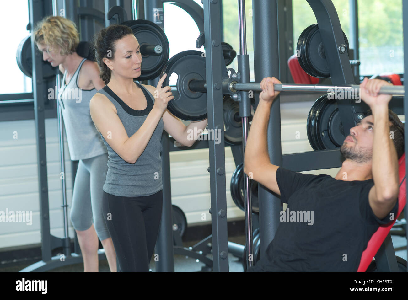People weight lifting in gym Stock Photo - Alamy