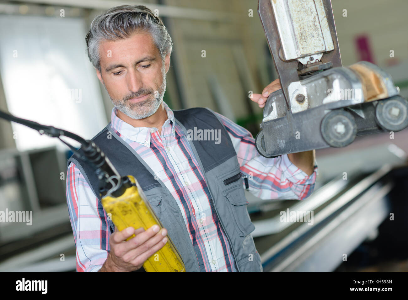 Worker operating robotic arm hi-res stock photography and images - Alamy