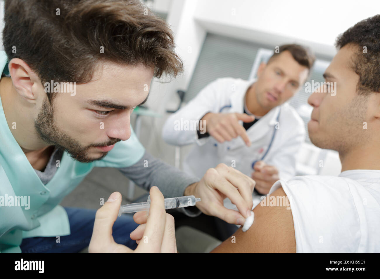 young doctor doing injured man tetanus toxoid injection Stock Photo - Alamy