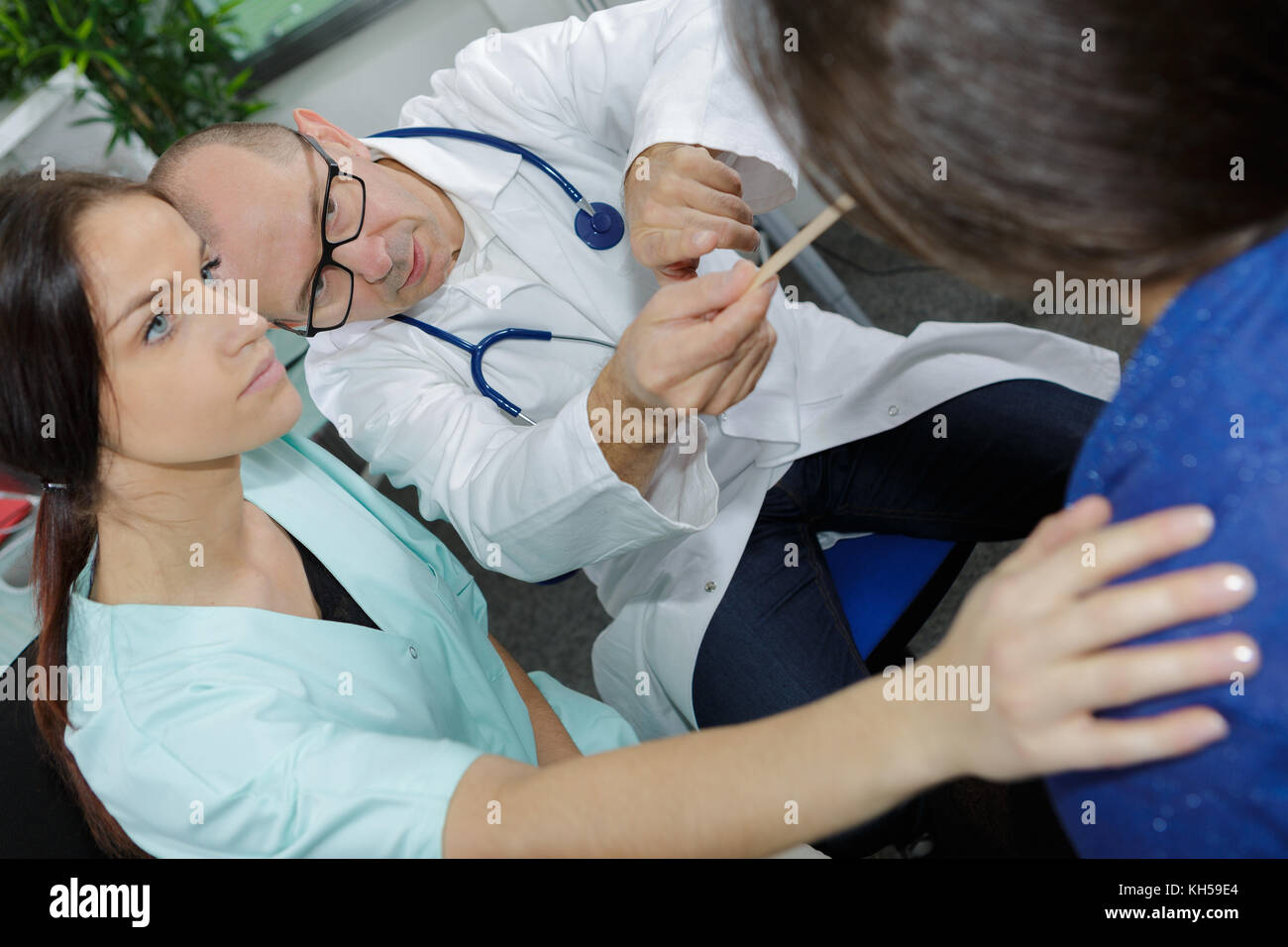 female doctor and student with patient Stock Photo - Alamy