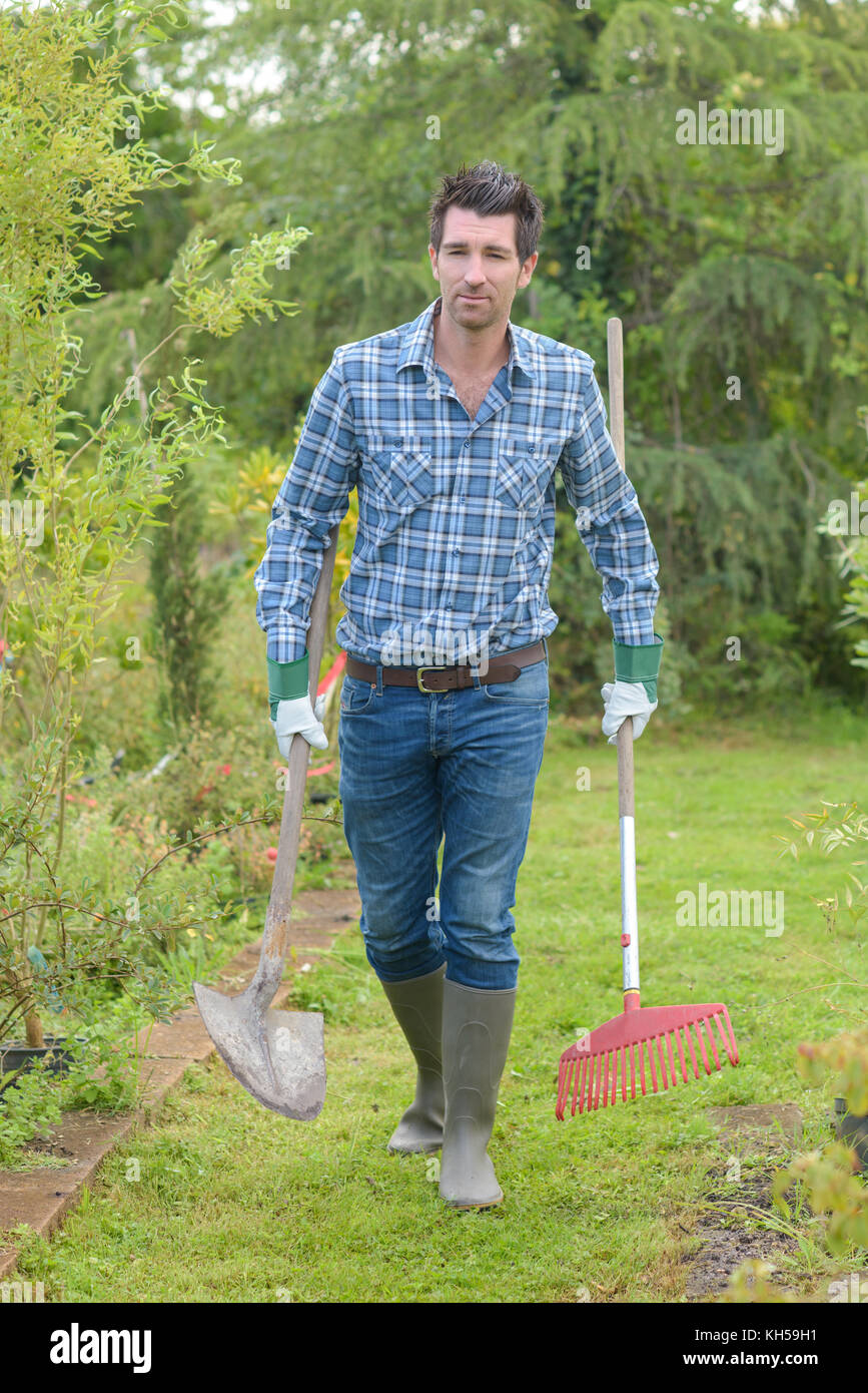 happy male gardener walking Stock Photo - Alamy