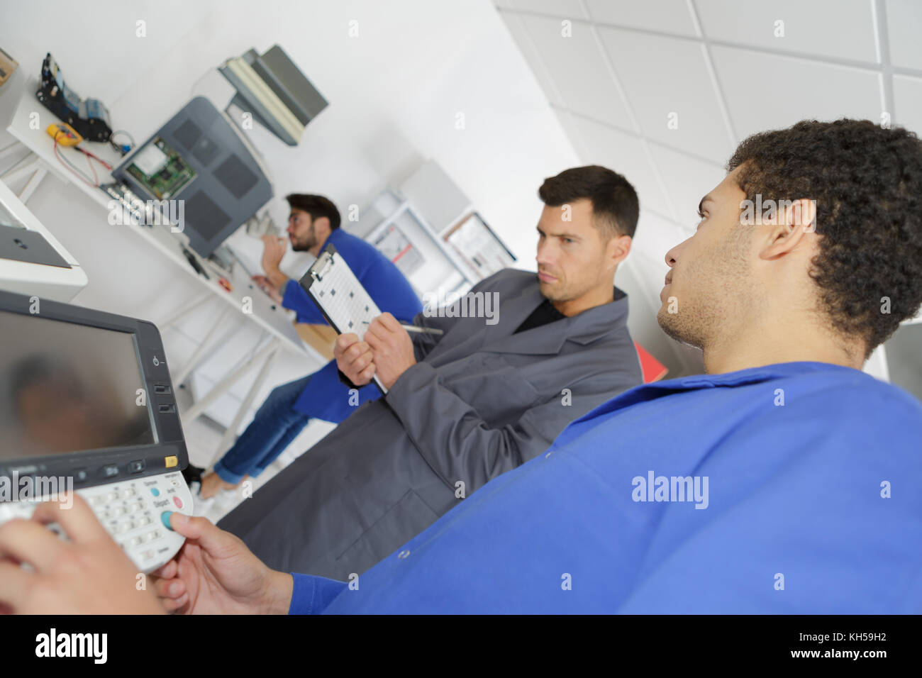 young students learning how to fix the office printer Stock Photo - Alamy