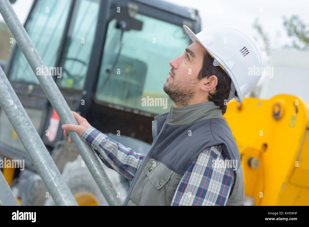 worker climbing on the steps Stock Photo - Alamy