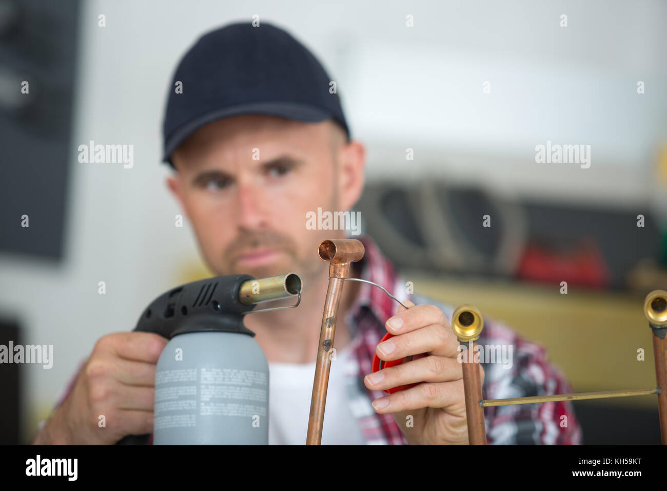 plumber welding copper and fittings with blowtorch Stock Photo - Alamy