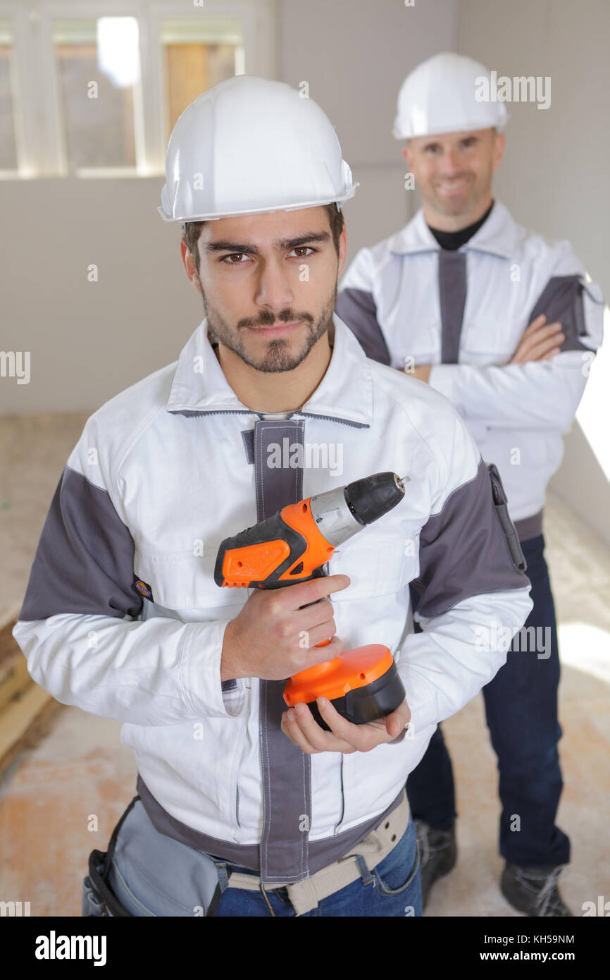 portrait of two workmen one holding cordless drill Stock Photo - Alamy