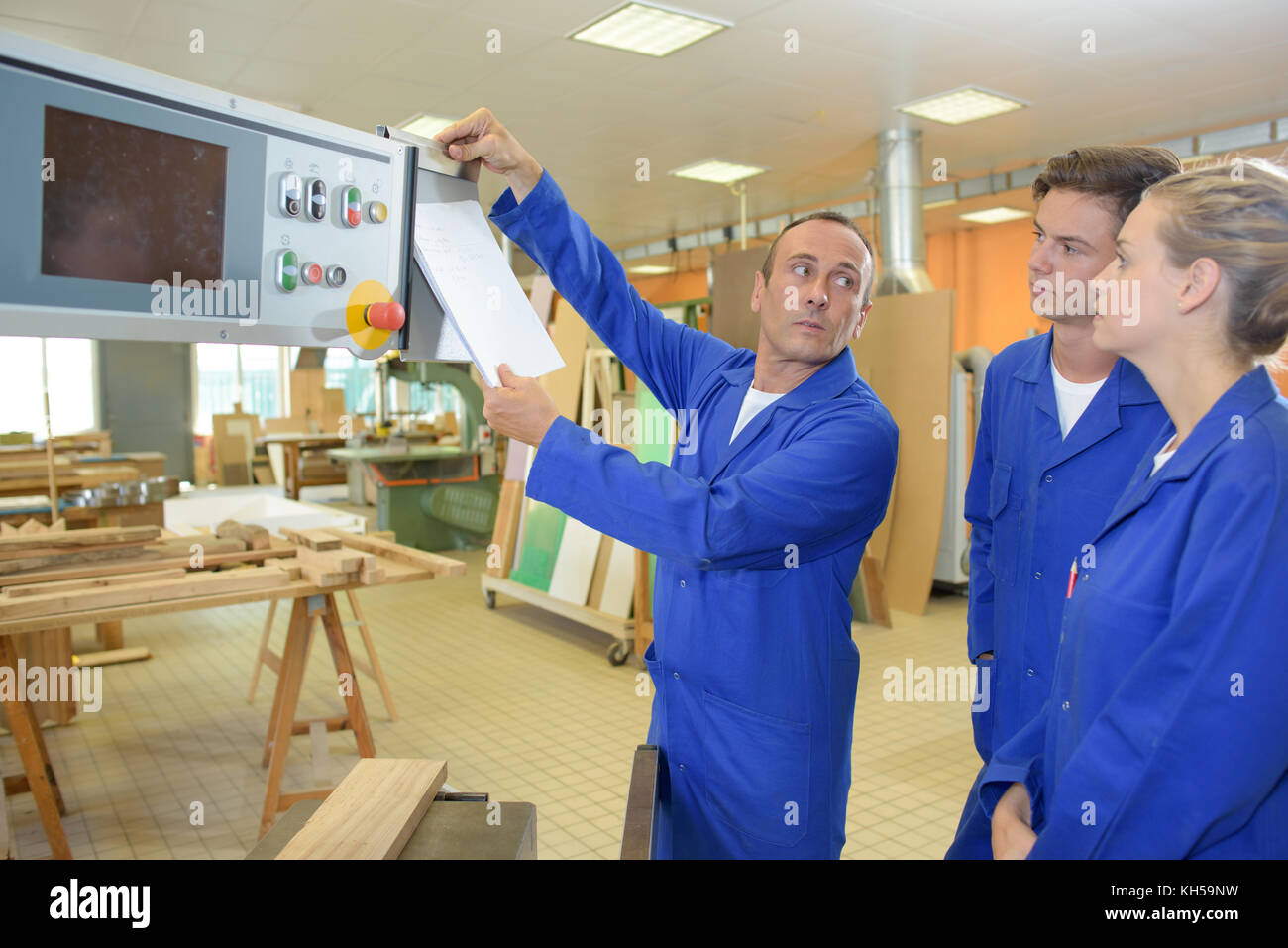 Man clipping papers to machine Stock Photo - Alamy