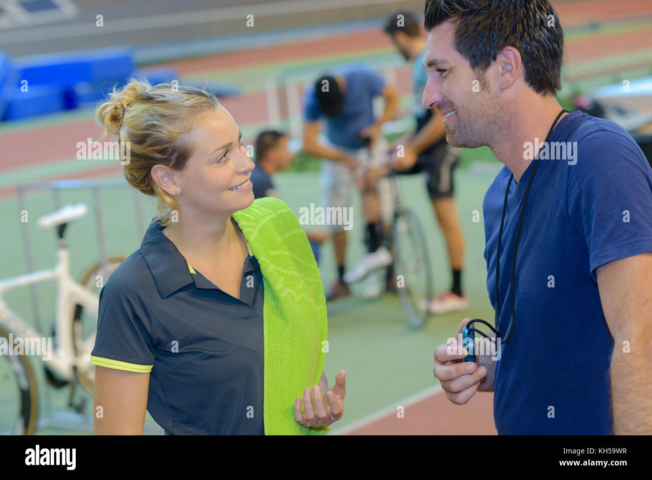 smiling couple of sportsmen outdoors talking Stock Photo - Alamy