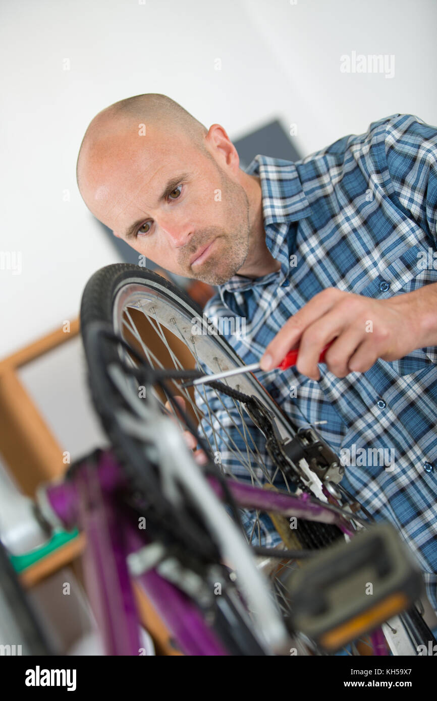 man fixing a bicycle Stock Photo - Alamy