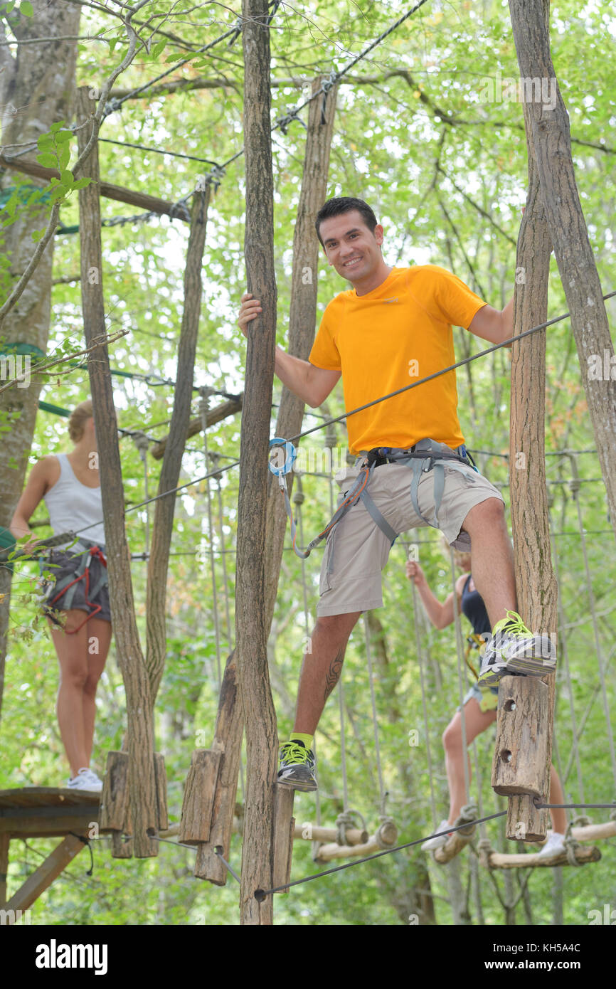 couple on a rope climbing in the adventure park Stock Photo - Alamy