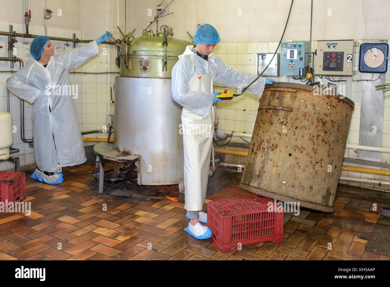 Worker operating controls of vat in factory Stock Photo - Alamy