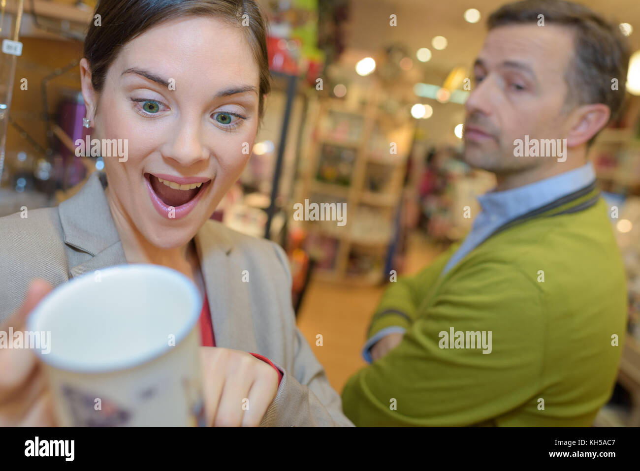 couple looking at items displayed in shopping in mall Stock Photo - Alamy