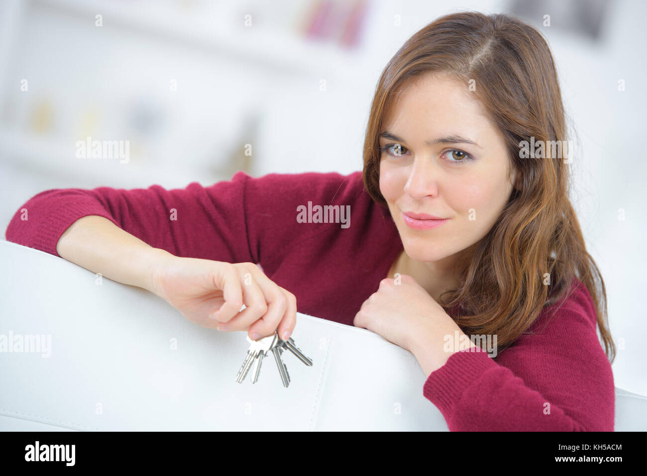happy woman holding house model and home keys Stock Photo - Alamy