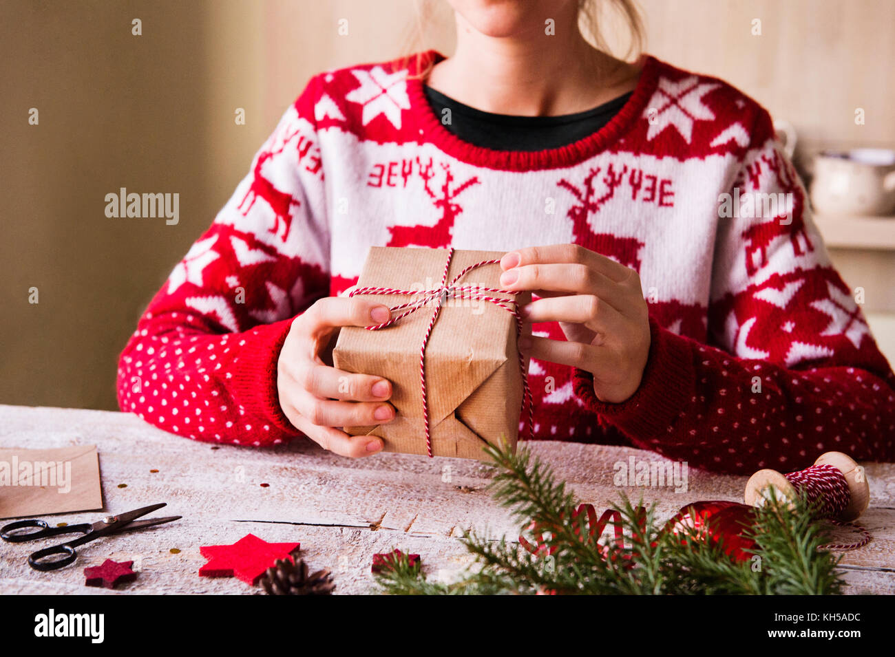 Unrecognizable woman wrapping a Christmas present Stock Photo - Alamy