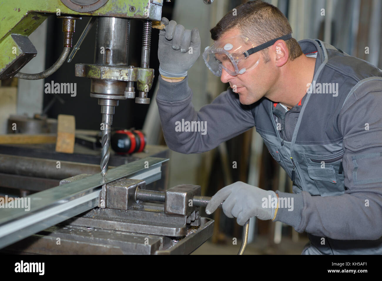 Man using bench drill Stock Photo - Alamy