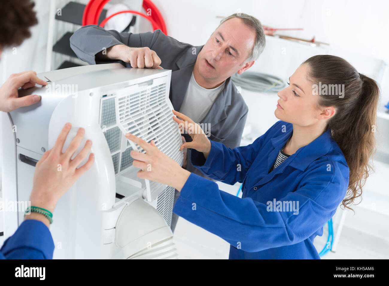 Students working on air conditioning unit Stock Photo - Alamy
