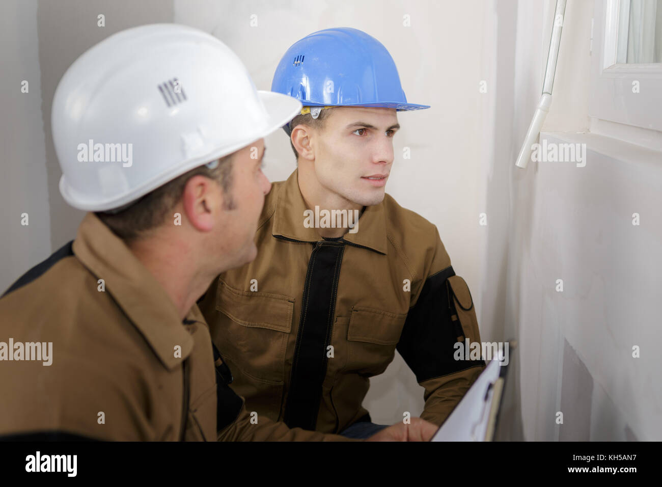 Workmen inspecting window Stock Photo - Alamy