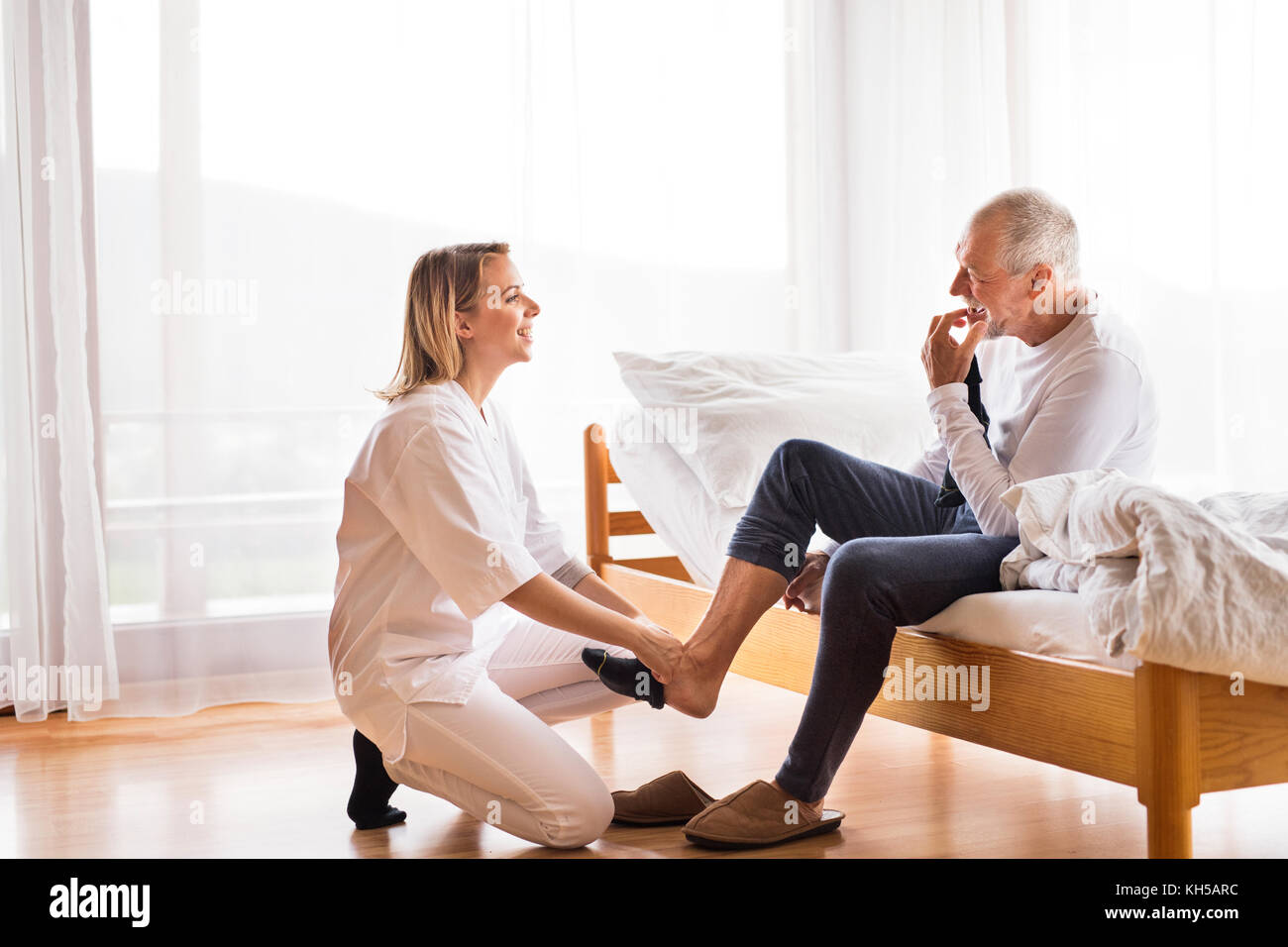 Health visitor and senior man during home visit Stock Photo - Alamy