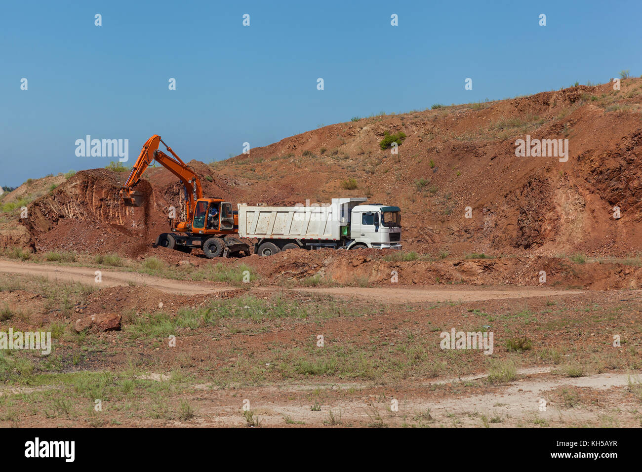 excavator loads a truck Stock Photo - Alamy