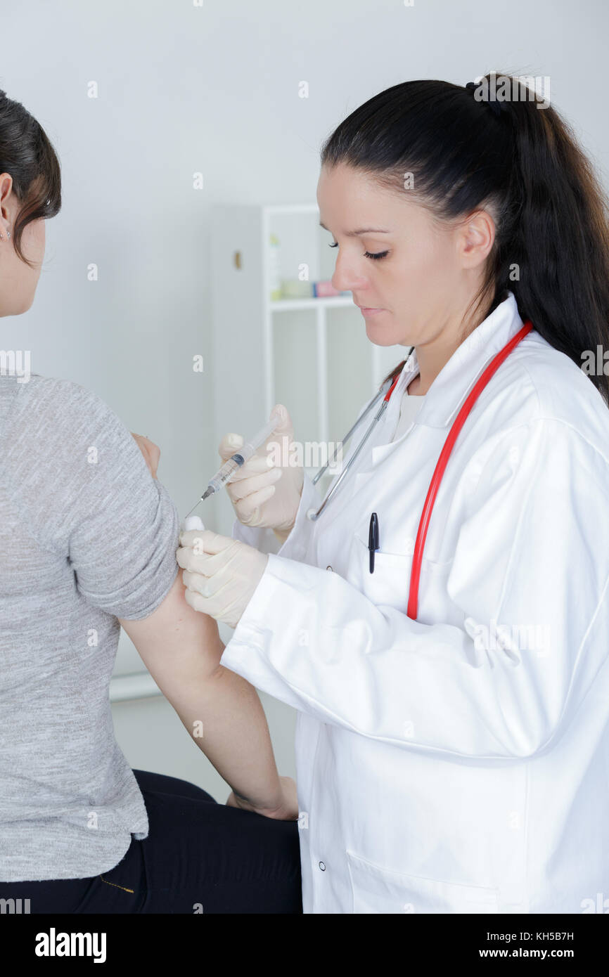 pediatrician giving an injection in arm Stock Photo - Alamy