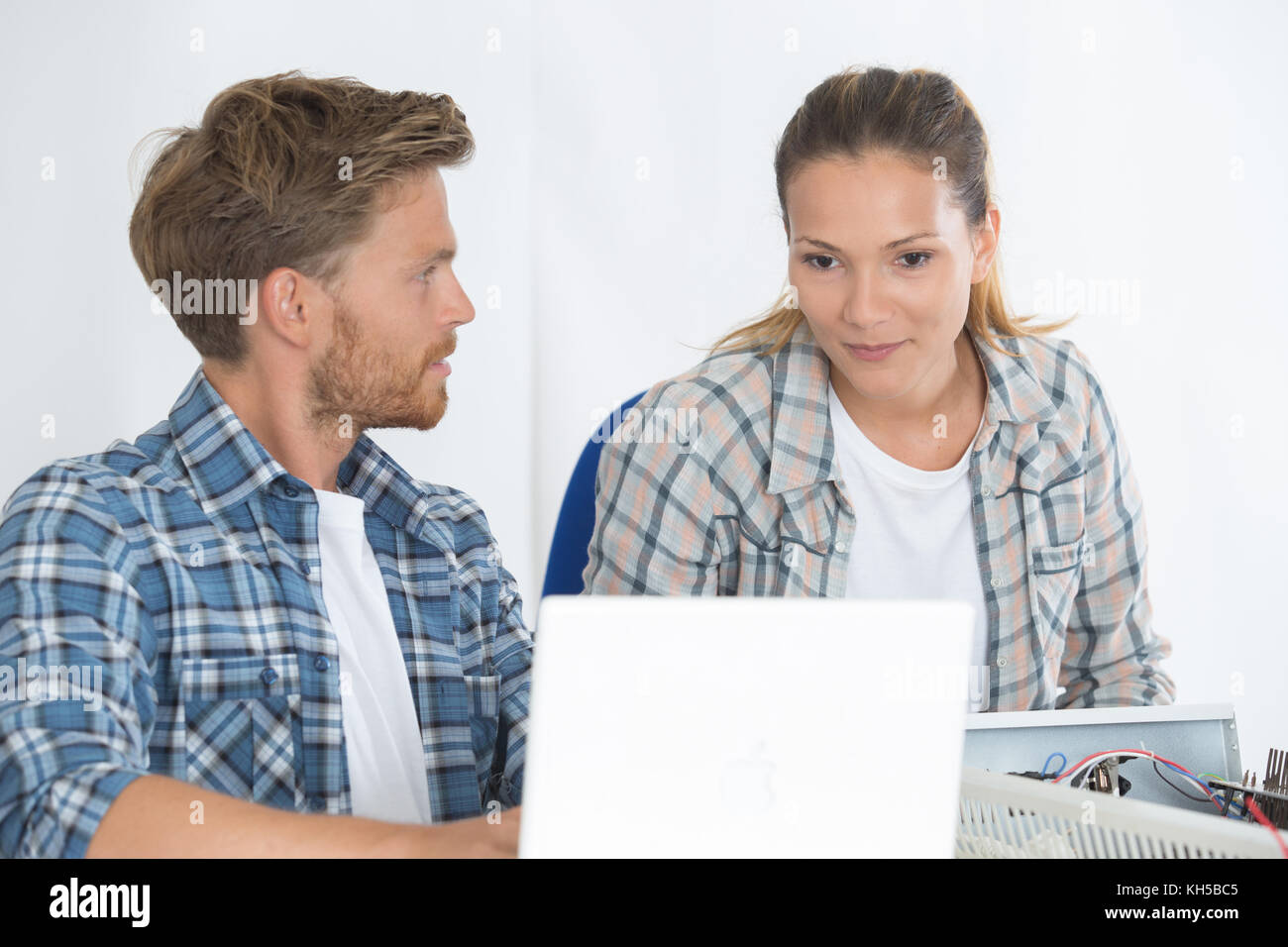programmers dressed casually together with computer Stock Photo - Alamy