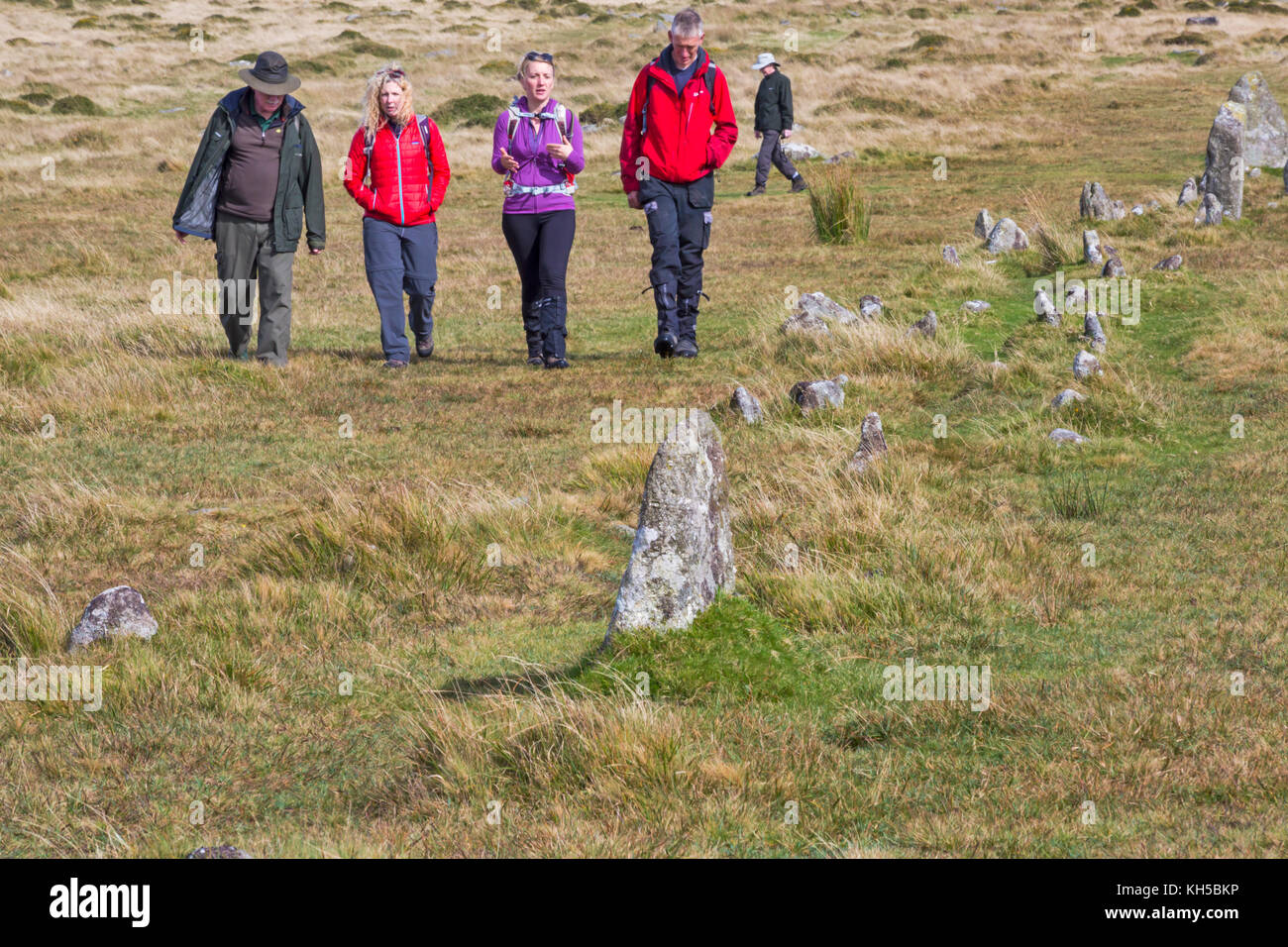 Visitors at Merrivale Prehistoric Settlement, walking by the Merrivale ...