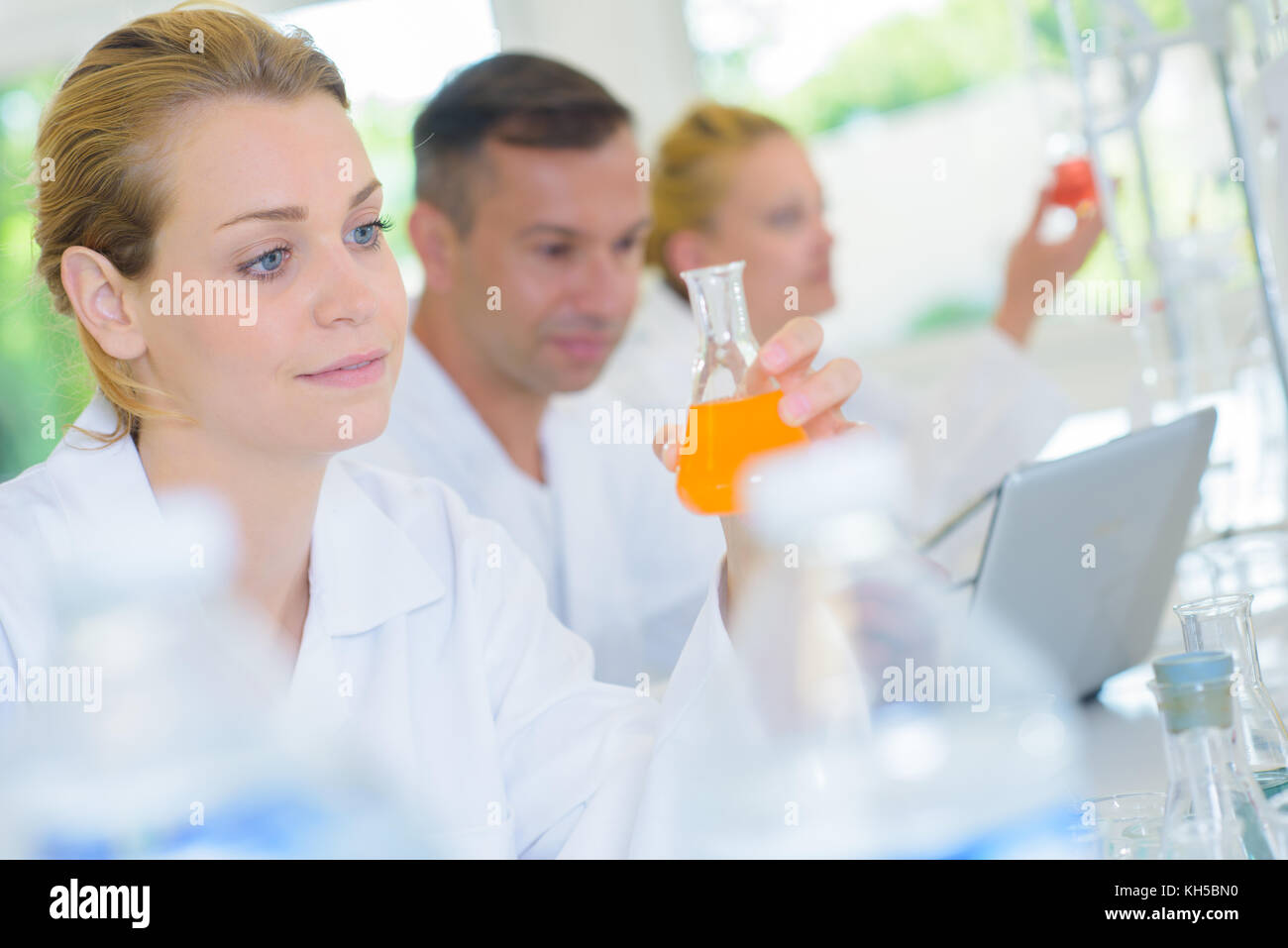 Female lab technician with dreamy expression Stock Photo - Alamy