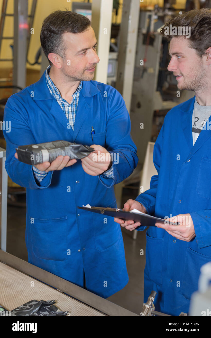 teacher with student in mechanics class Stock Photo - Alamy