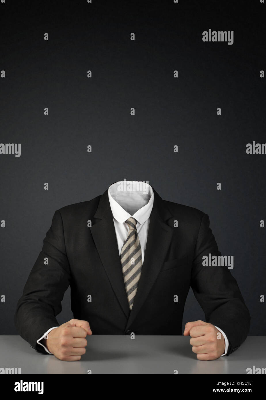 Businessman without head on dark background with copy-space Stock Photo ...