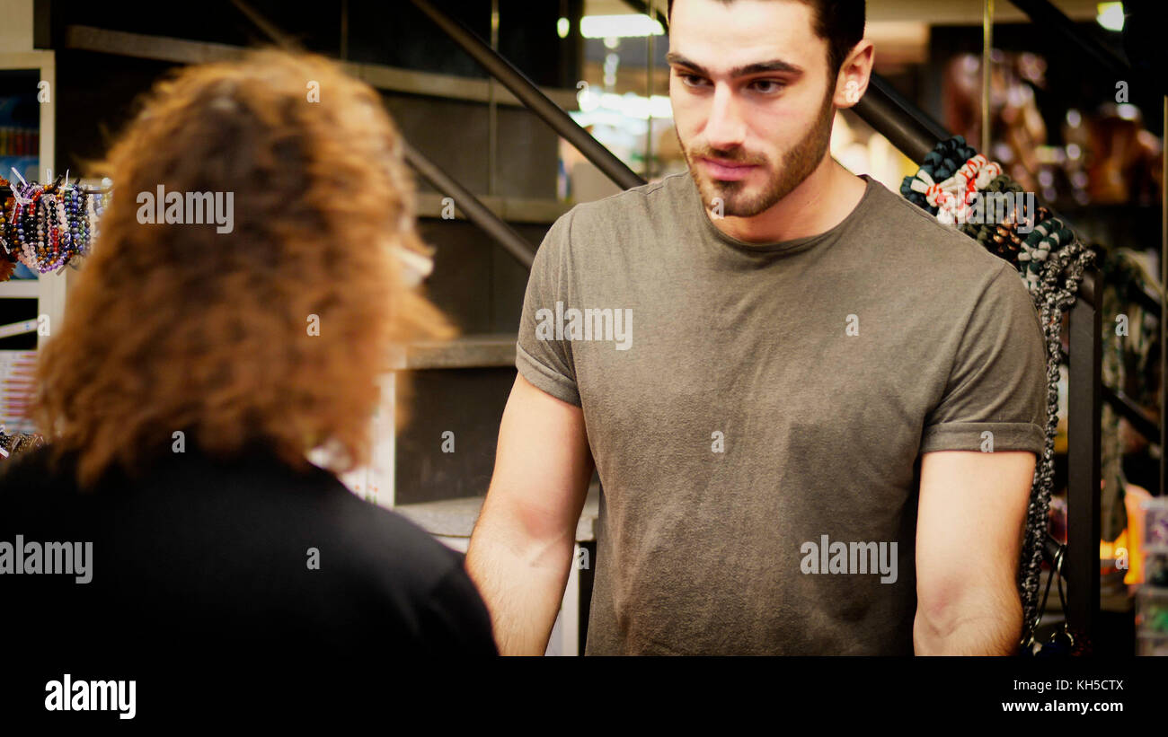 Shopkeeper serving customer Stock Photo - Alamy