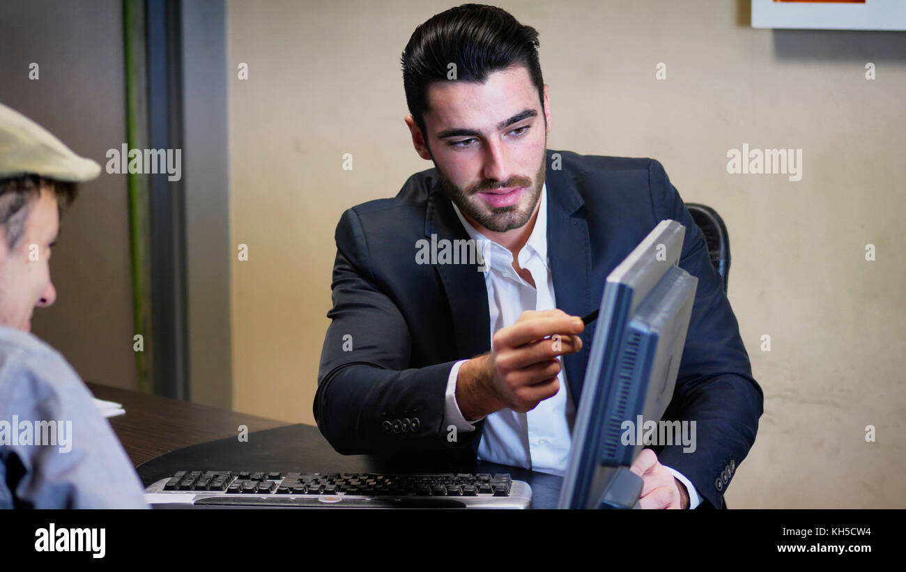 Businessman pointing at monitor screen Stock Photo - Alamy