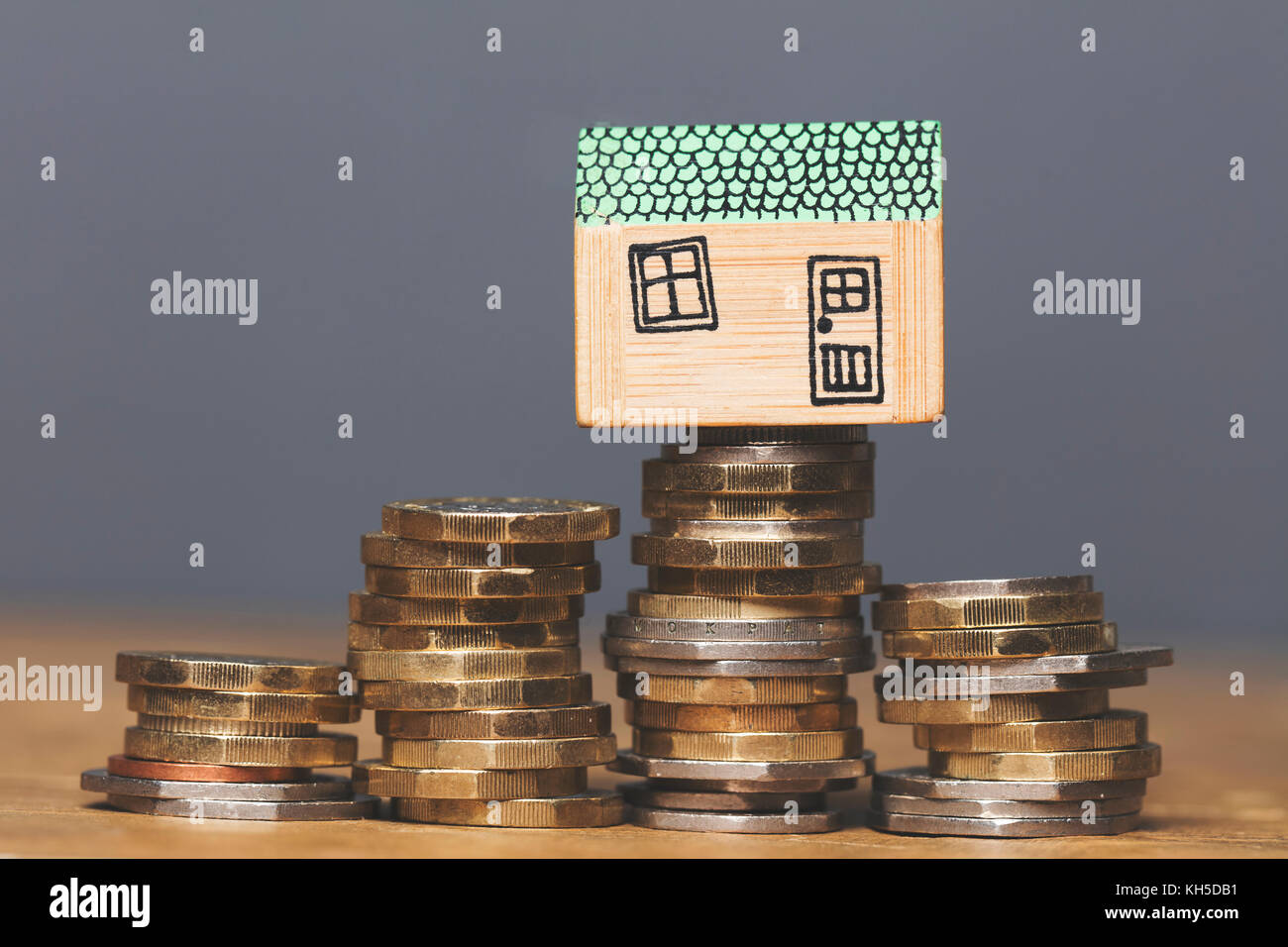 House model with coins. Home finance concept Stock Photo - Alamy