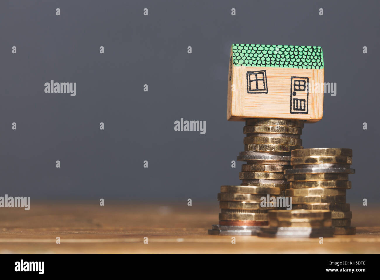 House model with coins. Home finance concept Stock Photo - Alamy