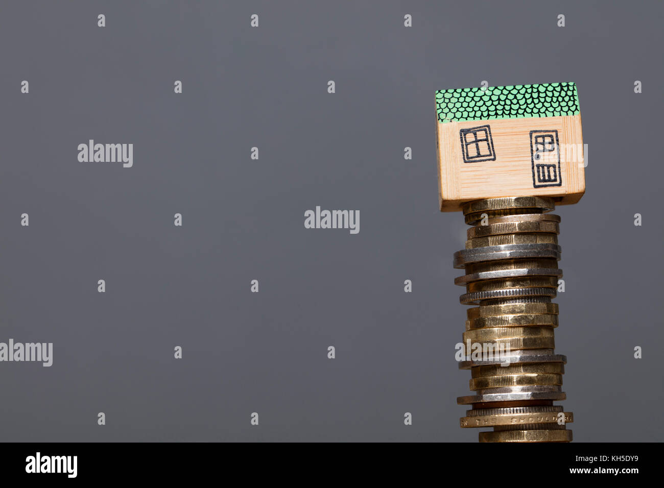 House model with coins. Home finance concept Stock Photo - Alamy
