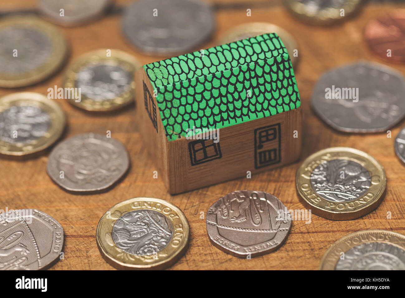 House model with coins. Home finance concept Stock Photo - Alamy